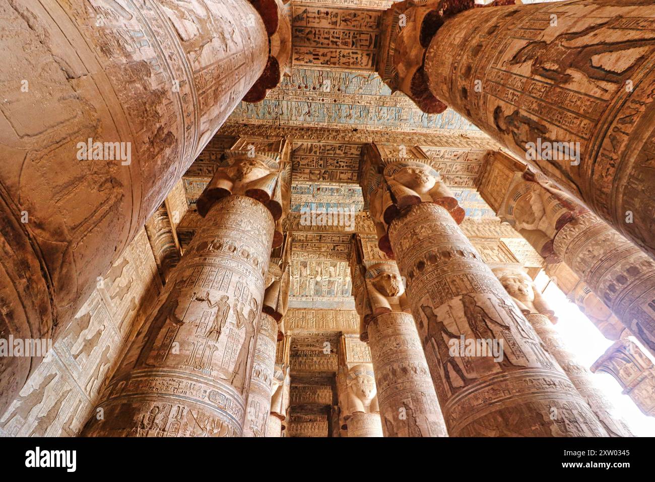 Magnificent hypostyle columns topped by faces of Hathor and vibrant ...
