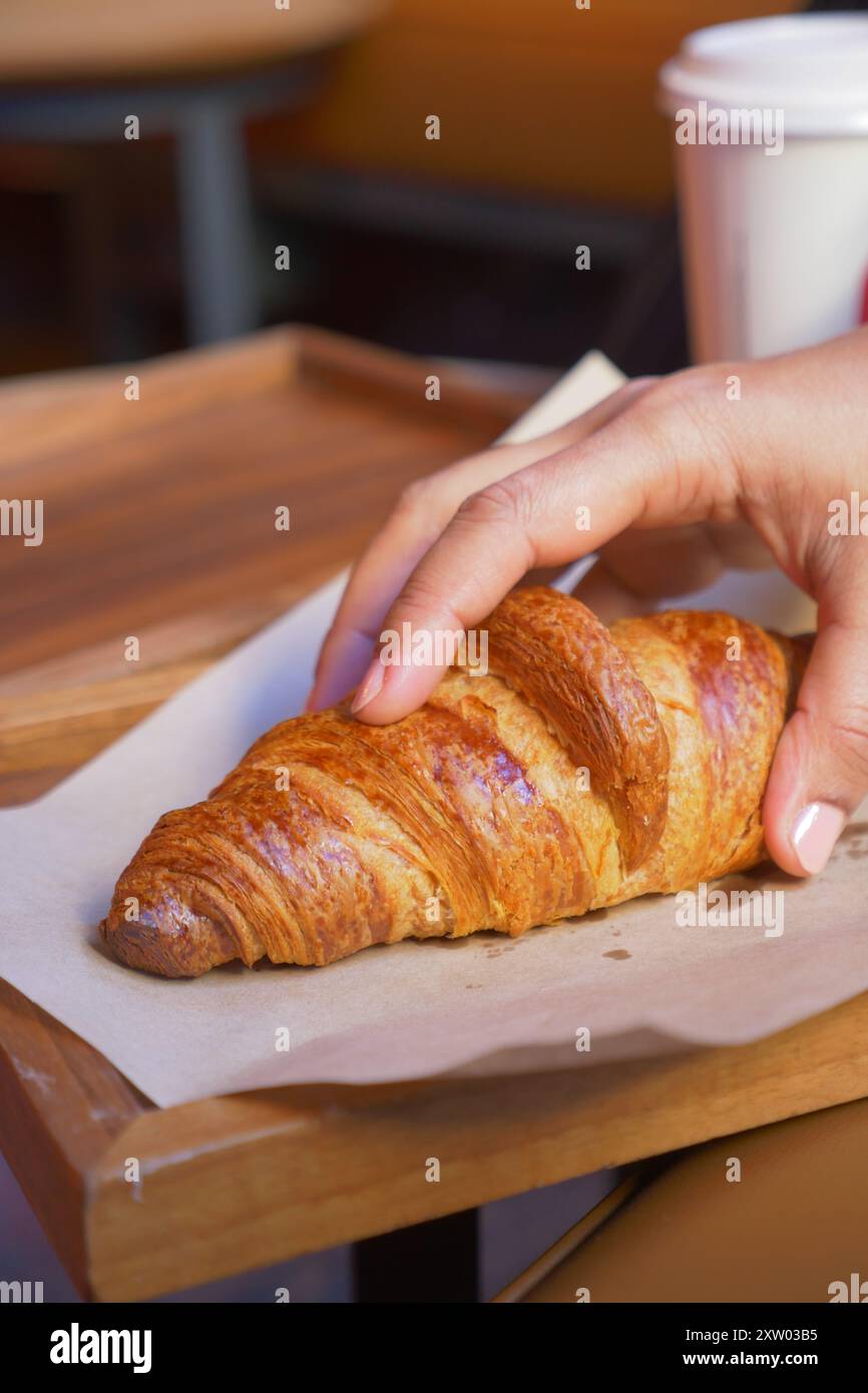 top view of hand pick fresh baked croissant Stock Photo - Alamy