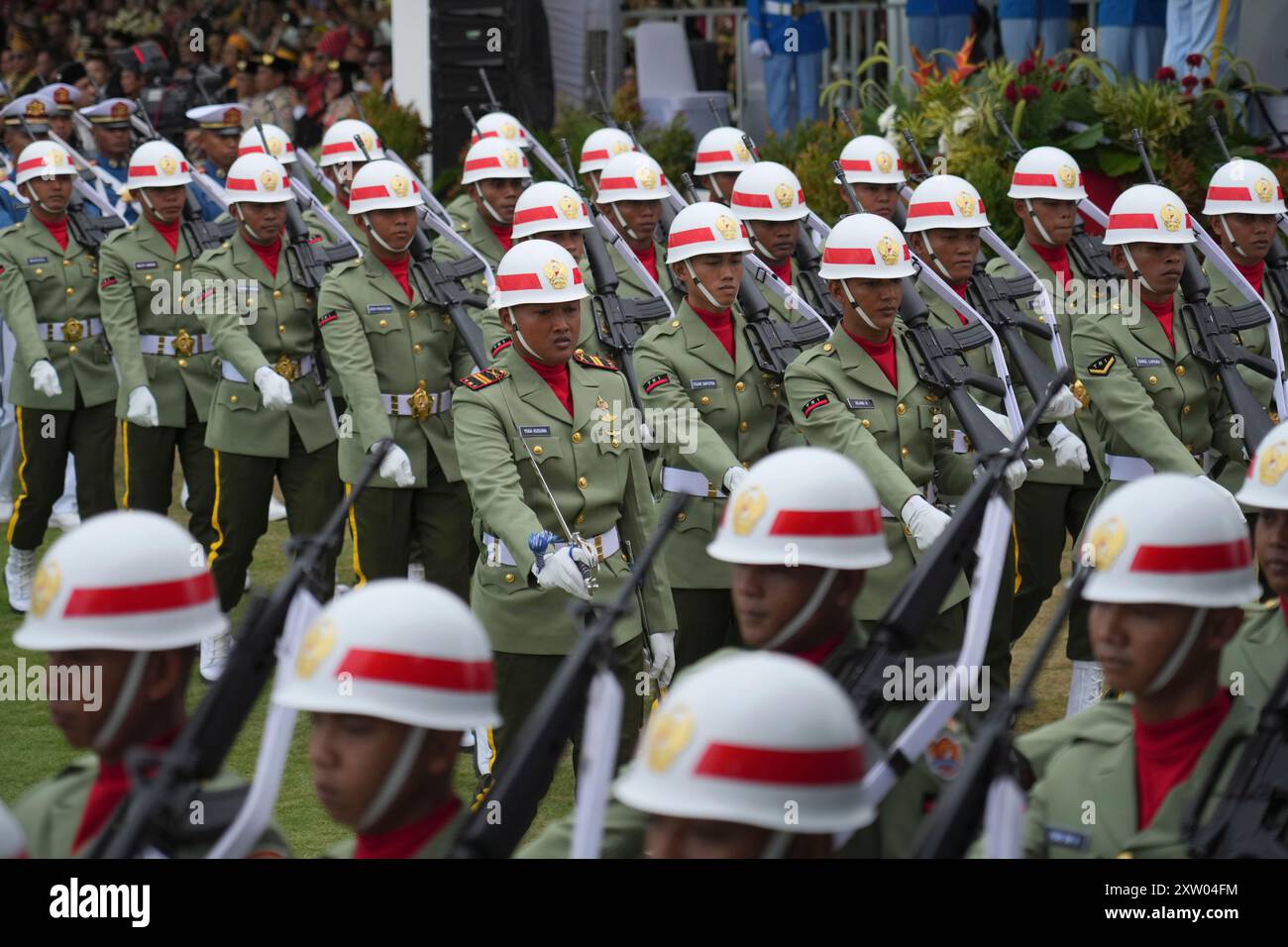Soldiers march before the start of a ceremony marking Indonesia's 79th ...