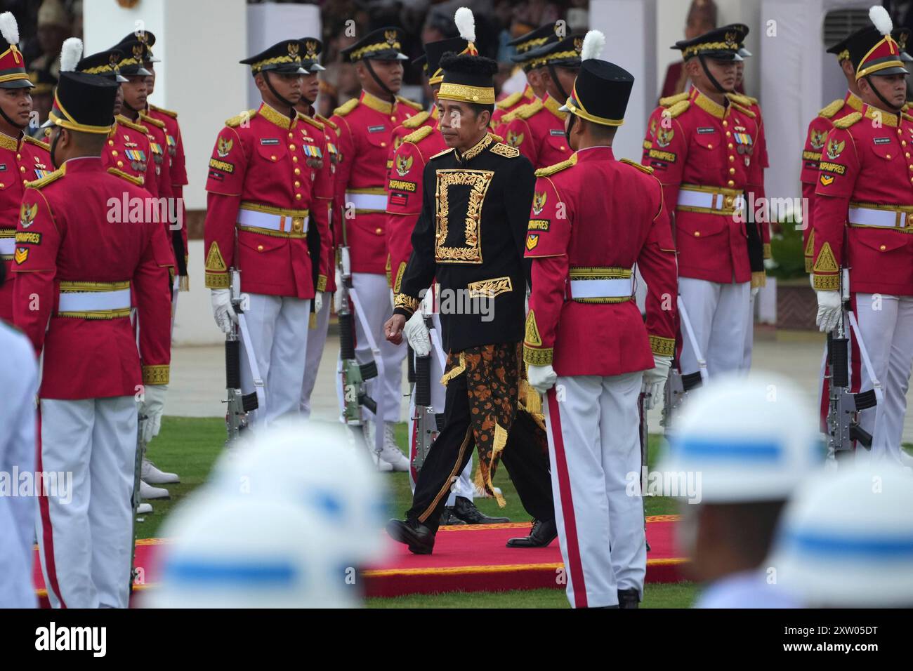 Indonesian President Joko Widodo walks among members of a honor guard ...