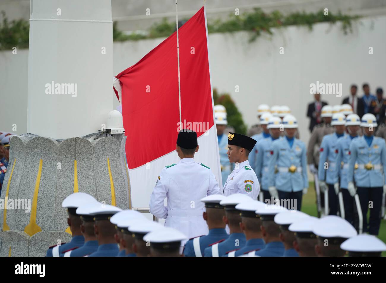 Flag bearers hoist the national Red-White flag during a ceremony ...