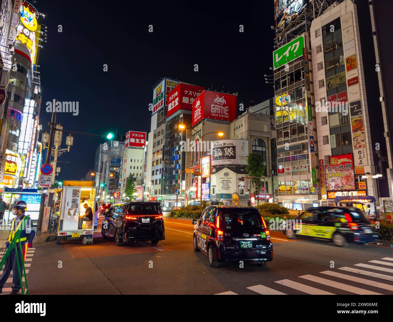 Modern commercial building with neon light at night on Yasukuni dori ...