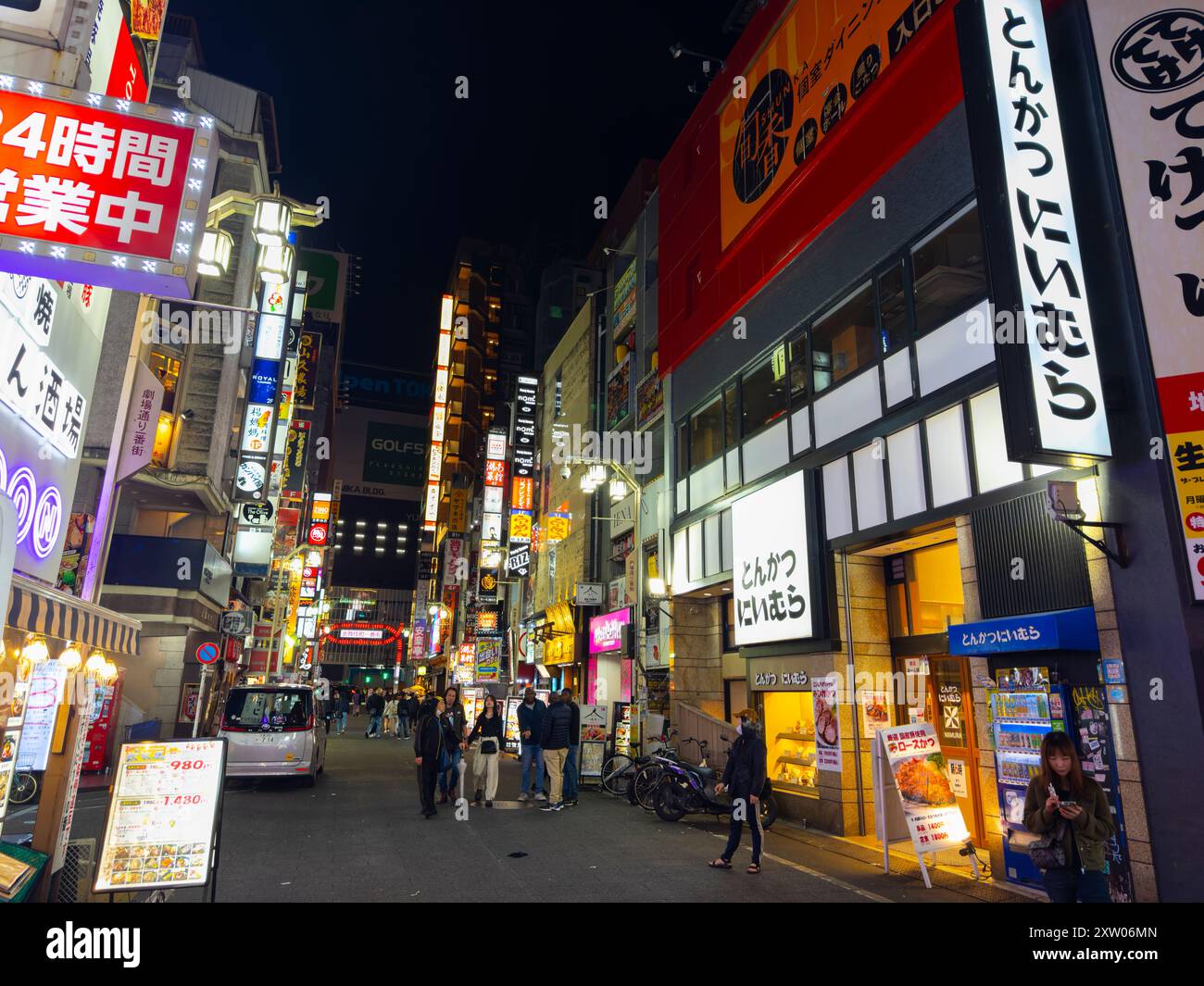 Shops and restaurants at night on Kabukicho Ichiban Gai Street in ...