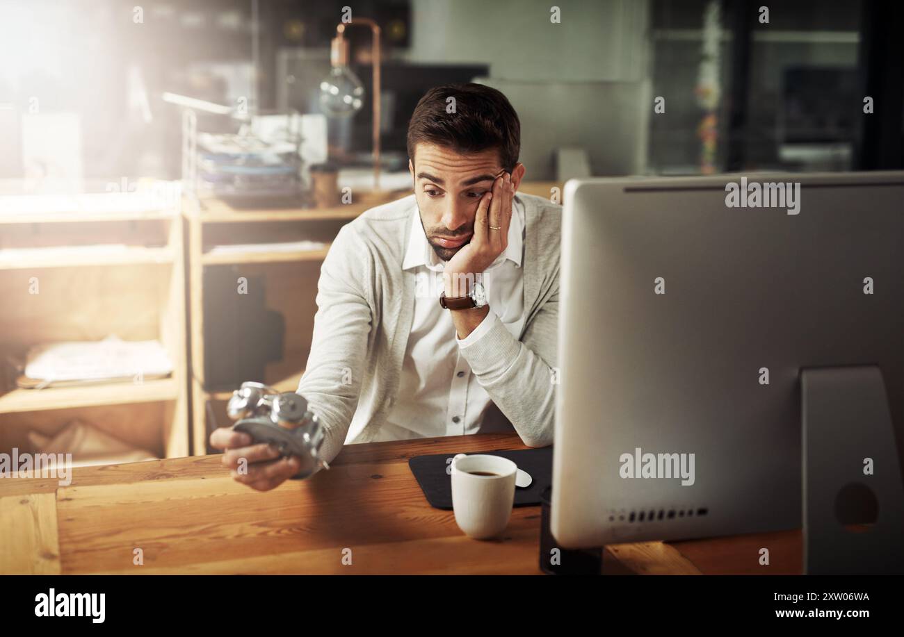 Man, alarm clock and office with tired, fatigue and burnout with ...
