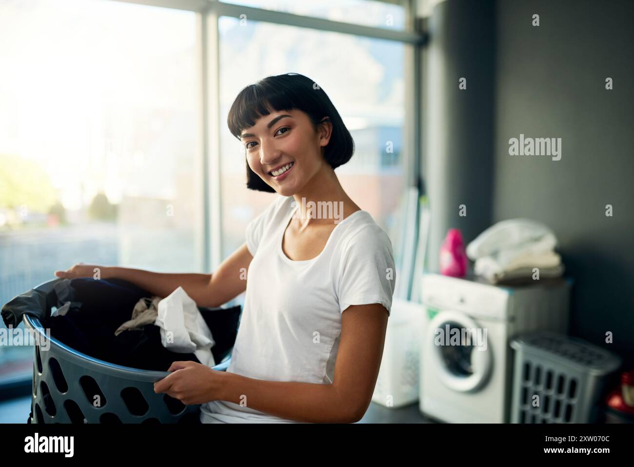 Portrait, basket and woman in home, laundry and sanitary with detergent ...