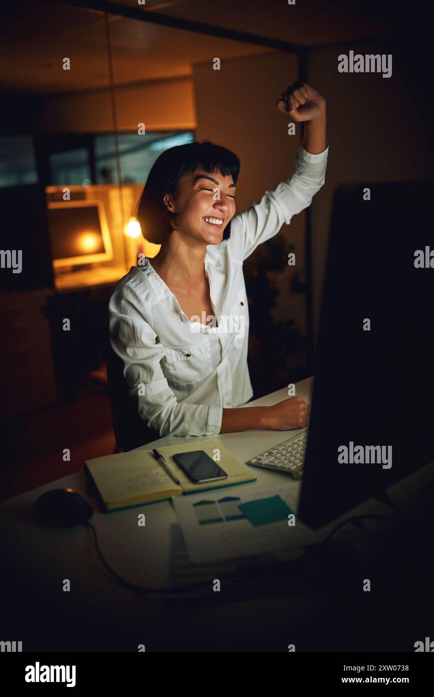 Asian woman, office and excited with fist pump at night on computer for ...