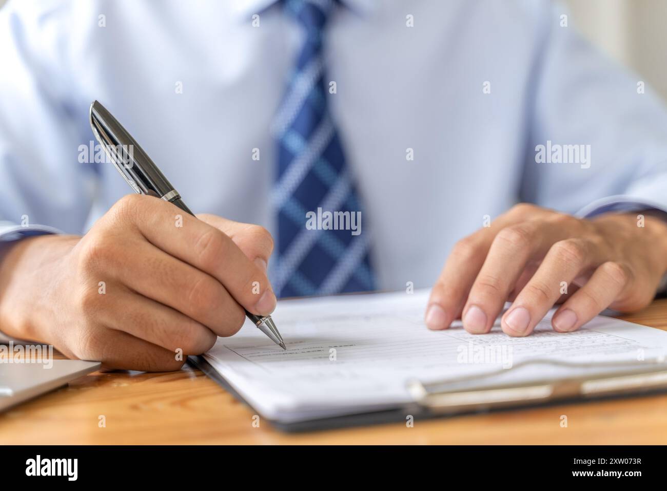 Businessman signing paperwork hi-res stock photography and images - Alamy