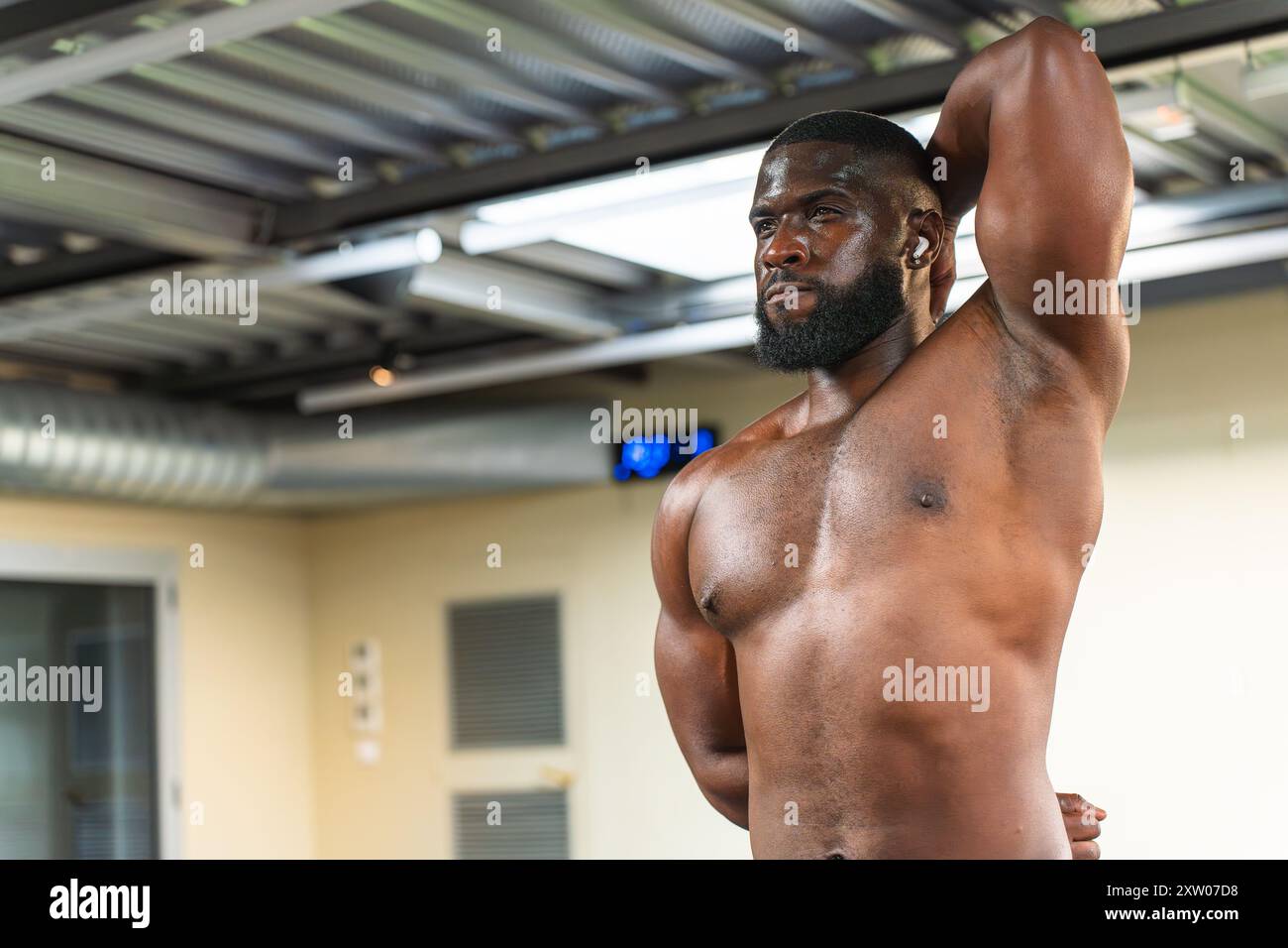 Black bodybuilder stretching his muscles before strength training Stock ...