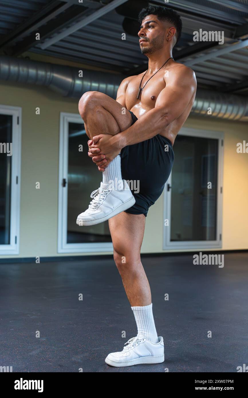 Martial arts fighter stretching his muscles before training Stock Photo ...