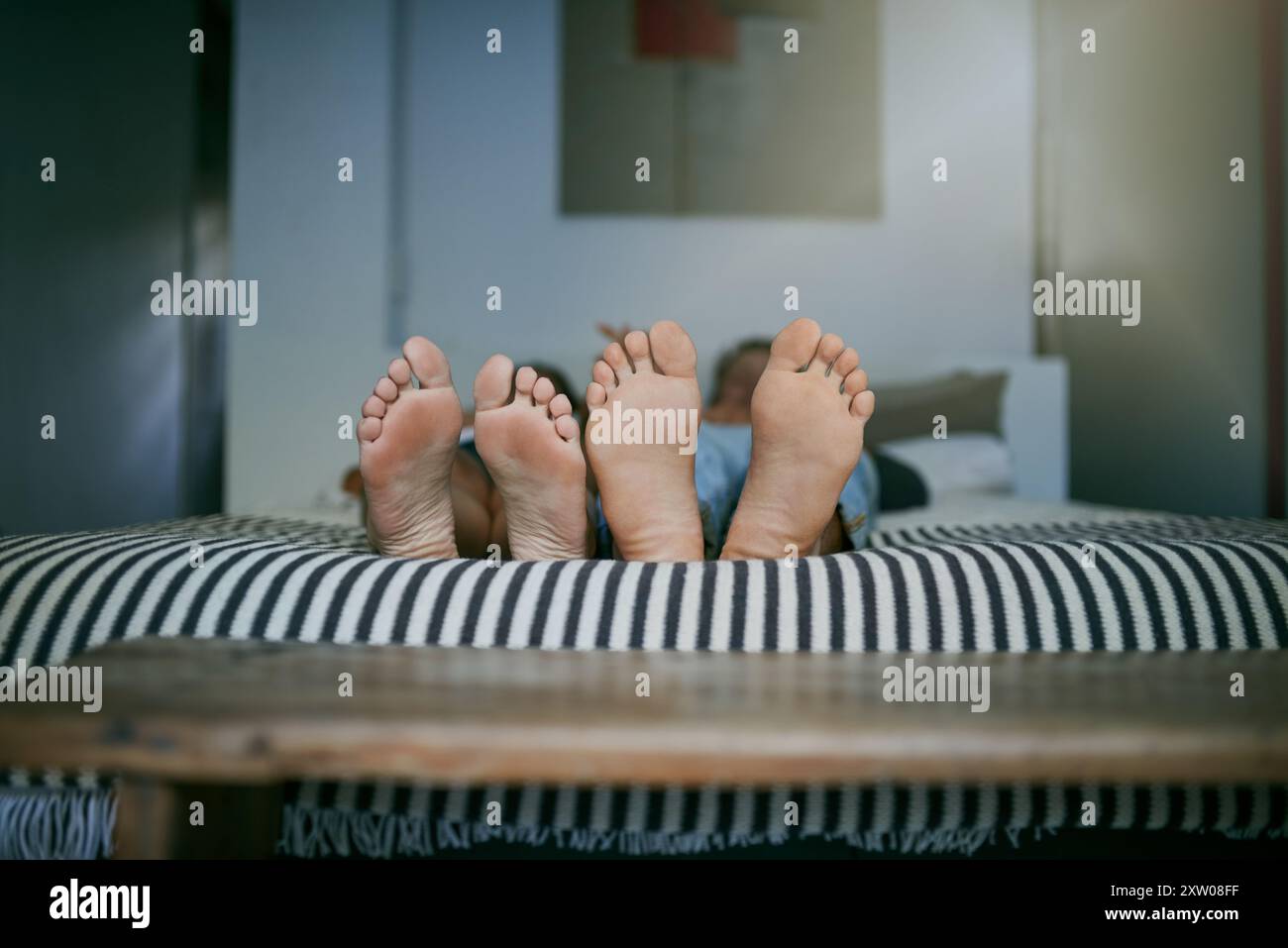 Couple, closeup and feet in bed for sleeping, relax and peace at night ...