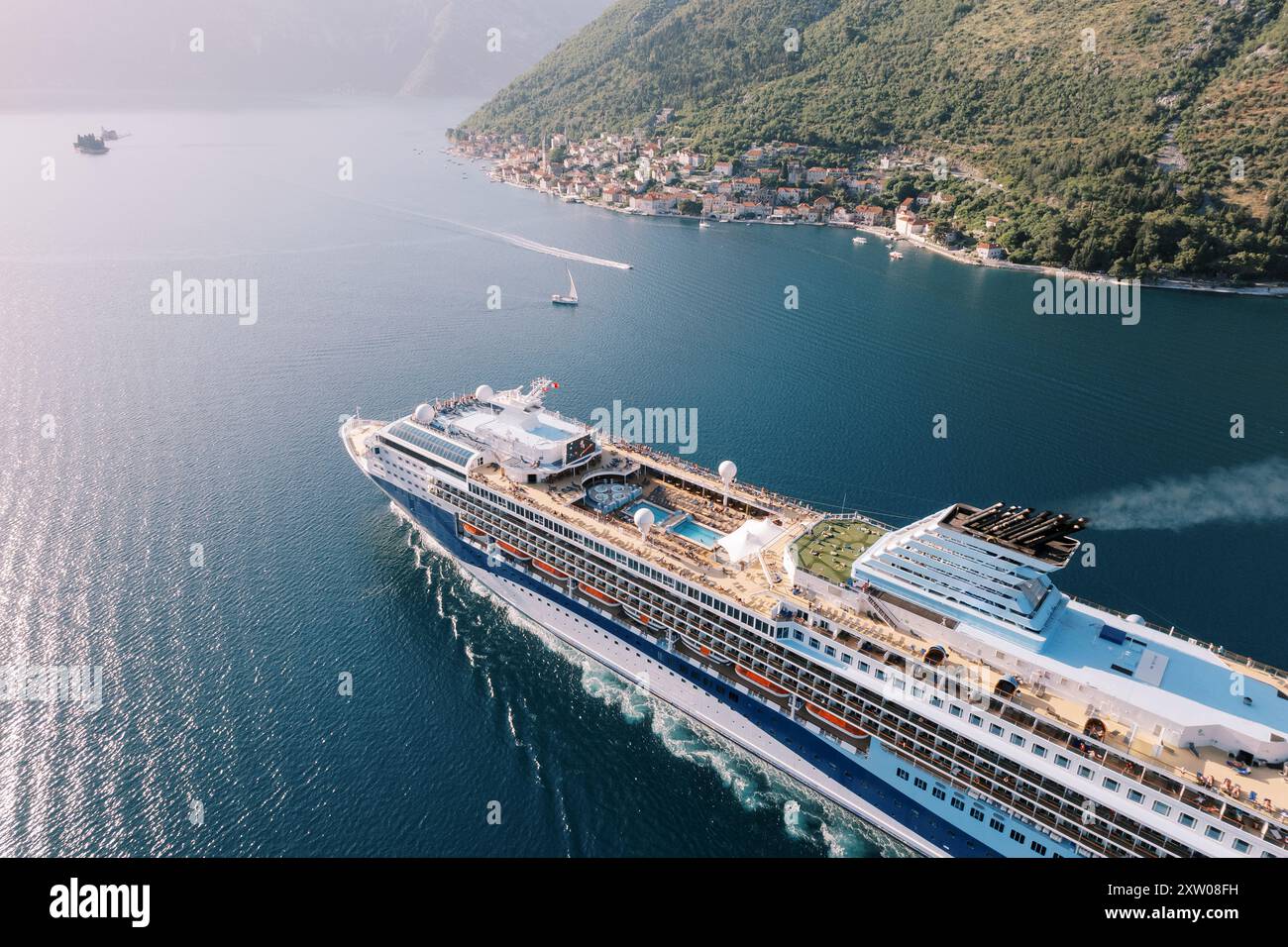 Large cruise ship with swimming pools on the deck floats on the sea ...