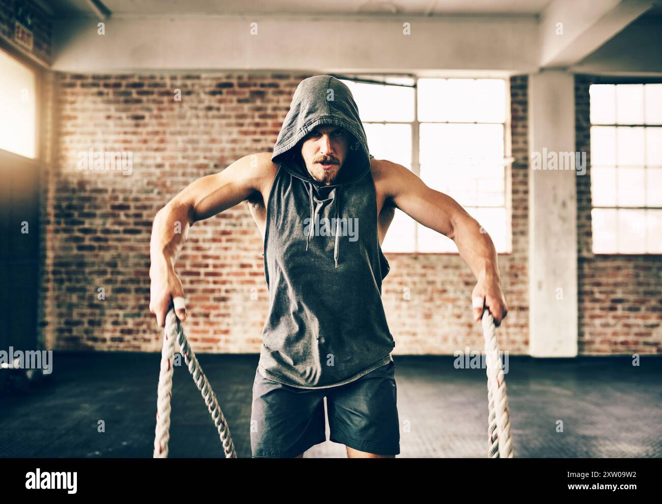 Man, bodybuilder and rope for workout at gym for bodybuilding with ...