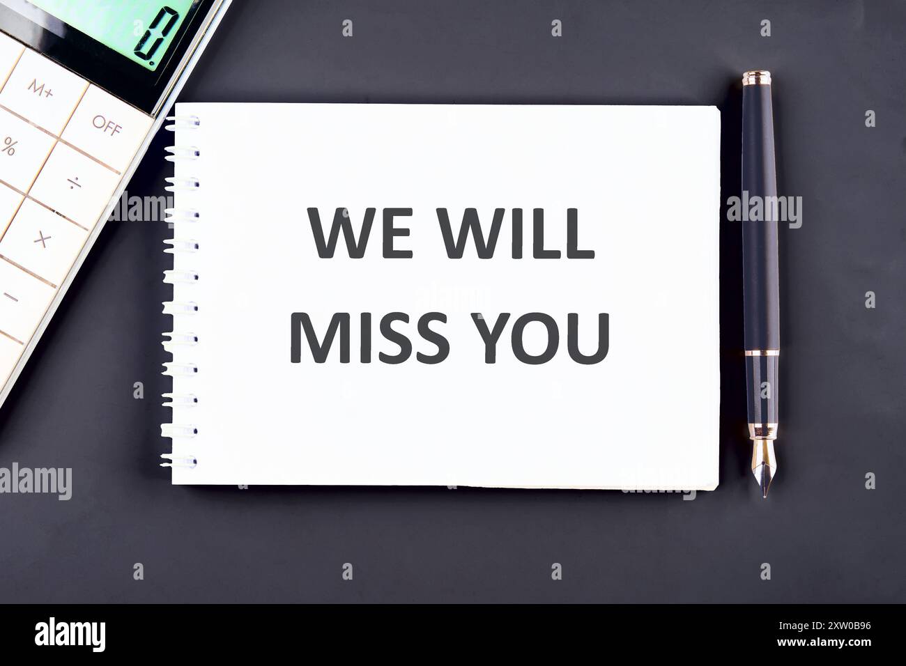 WE WILL MISS YOU written in a notebook, top view in a composition with ...