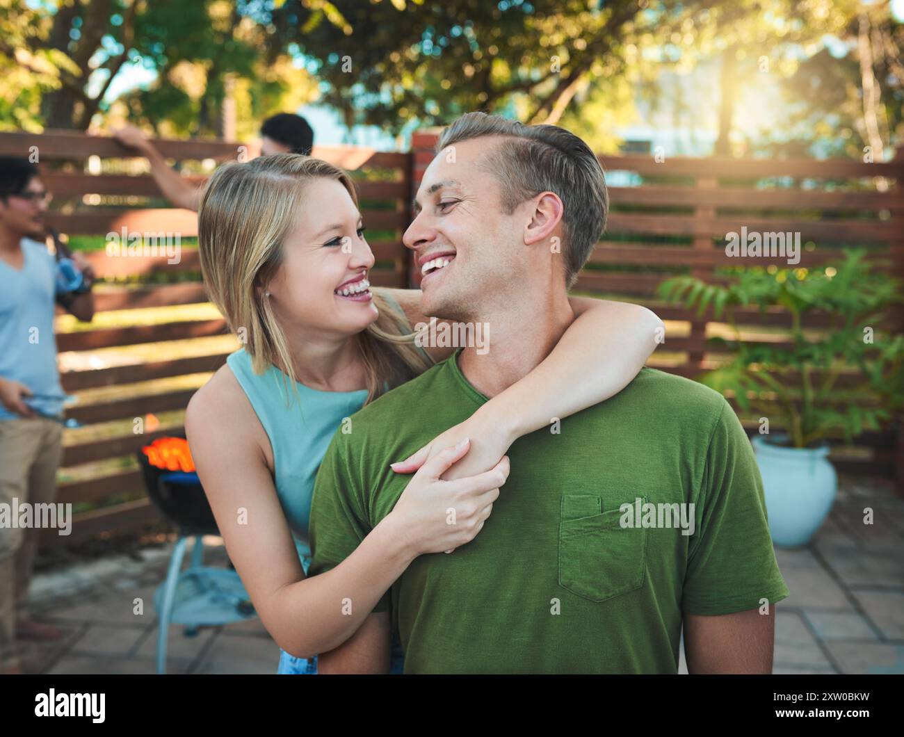 Couple, happy and barbecue outdoor with friends, drinks and fire for ...