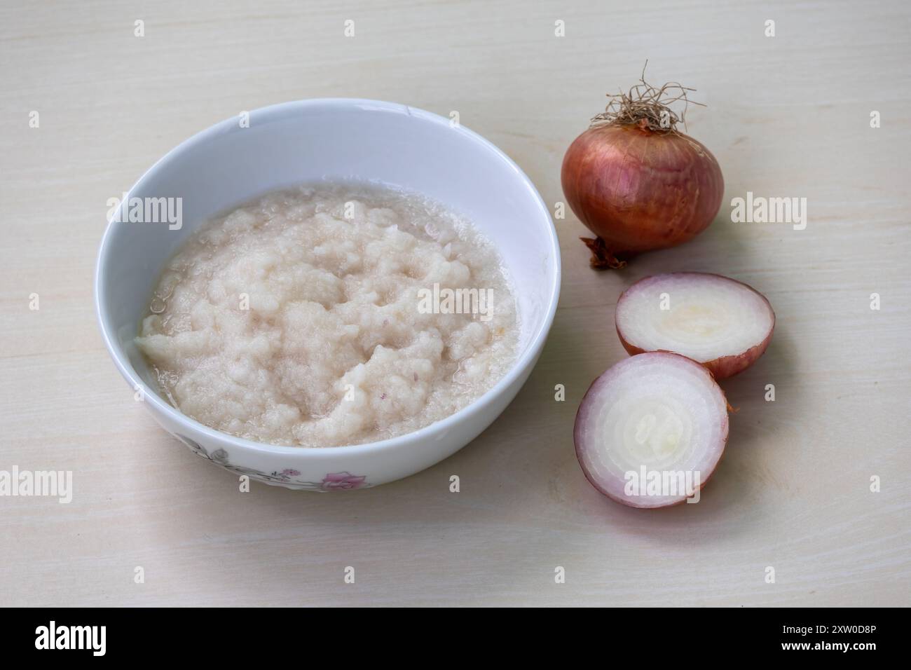 Onion paste (peyaj bata) in a white bowl. It is a common ingredient in ...