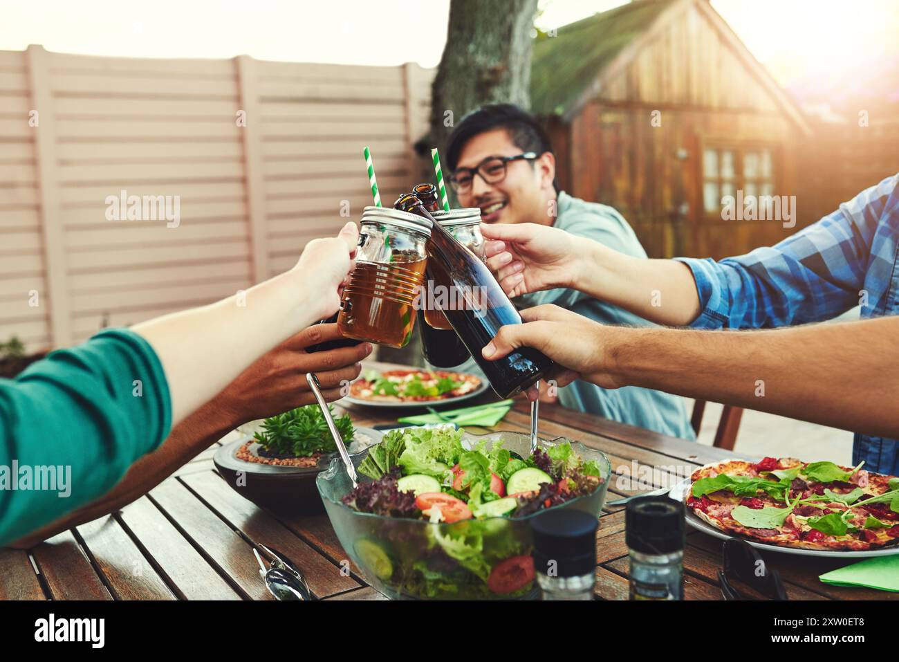 Dinner, alcohol and friends in backyard for toast, celebrate and ...