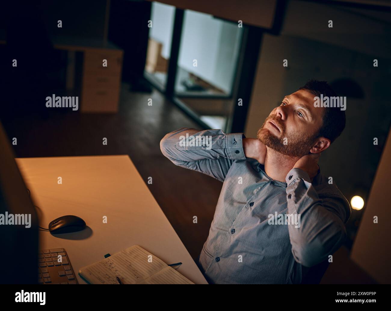 Business, man and neck pain in office at night with burnout, overtime ...