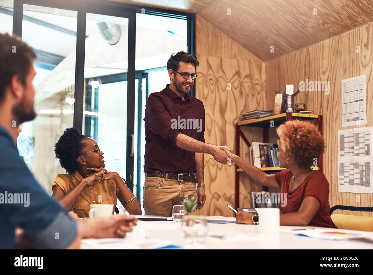 Office, business people and shaking hands in meeting for welcome ...