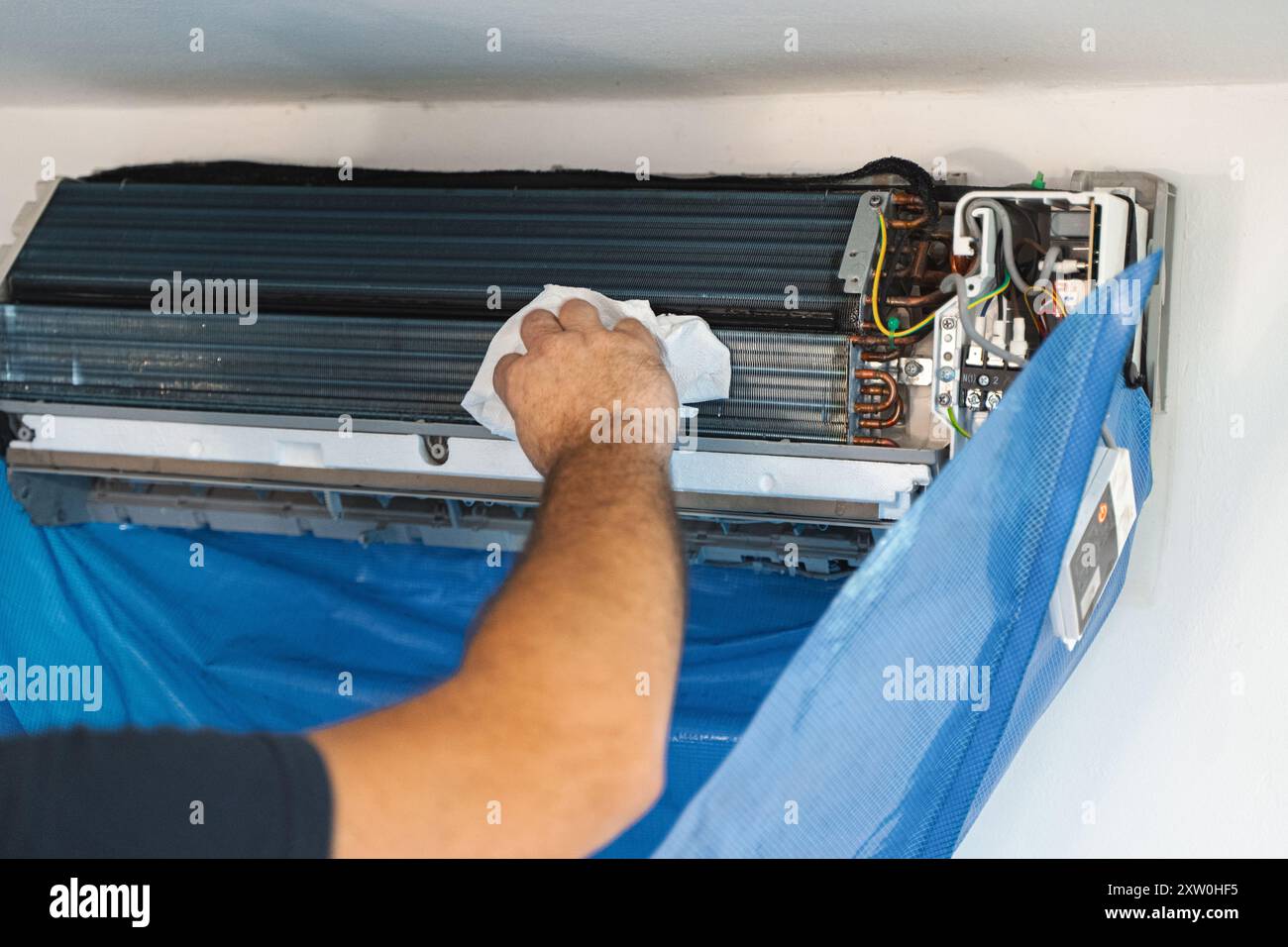 The technician are cleaning the air conditioner by spraying water Stock ...