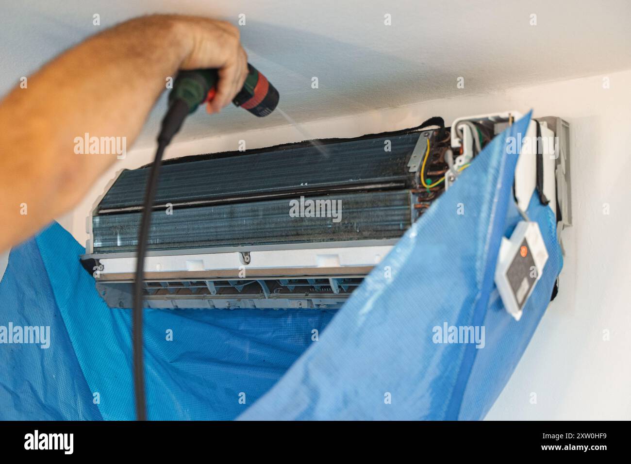 The technician are cleaning the air conditioner by spraying water Stock ...