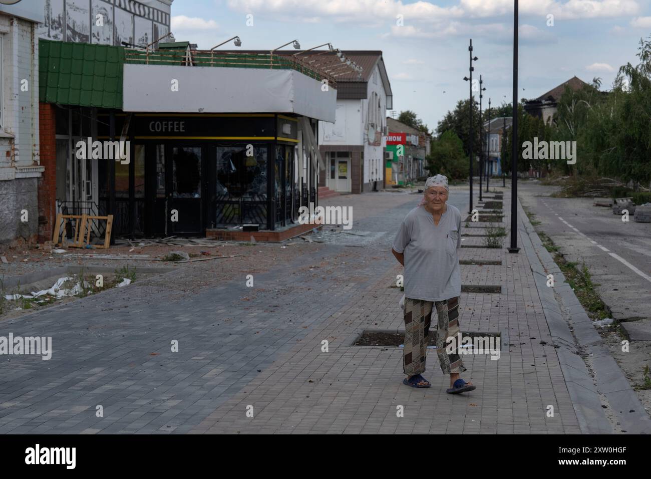 A local resident walks past at a city centre in Sudzha, Kursk region ...