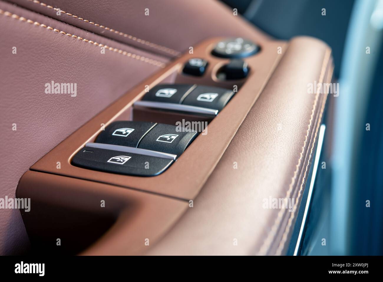 A detailed view of a luxury car's control panel, featuring sleek window ...