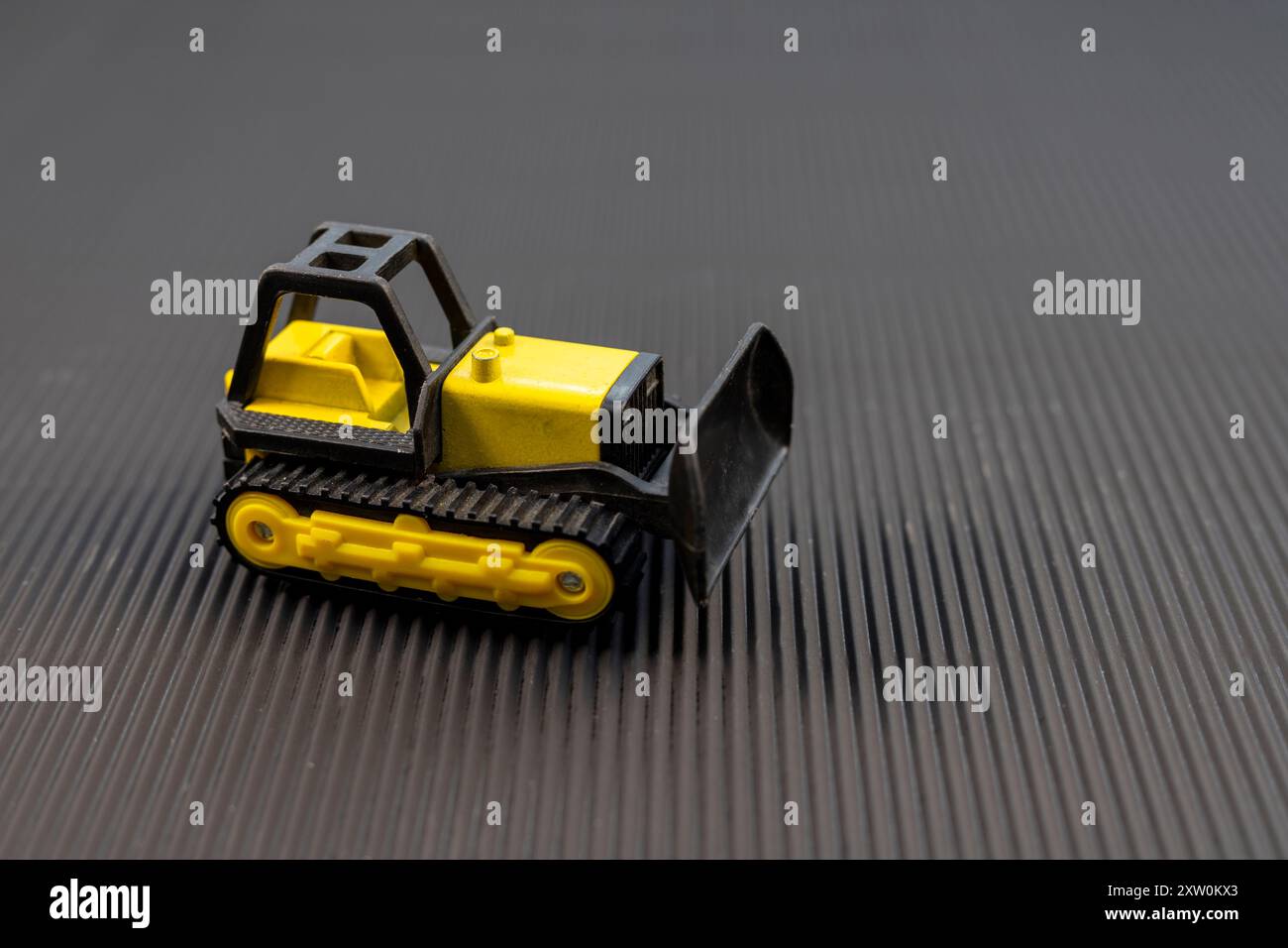 Close-up of Yellow Toy Bulldozer on Black Surface Stock Photo - Alamy