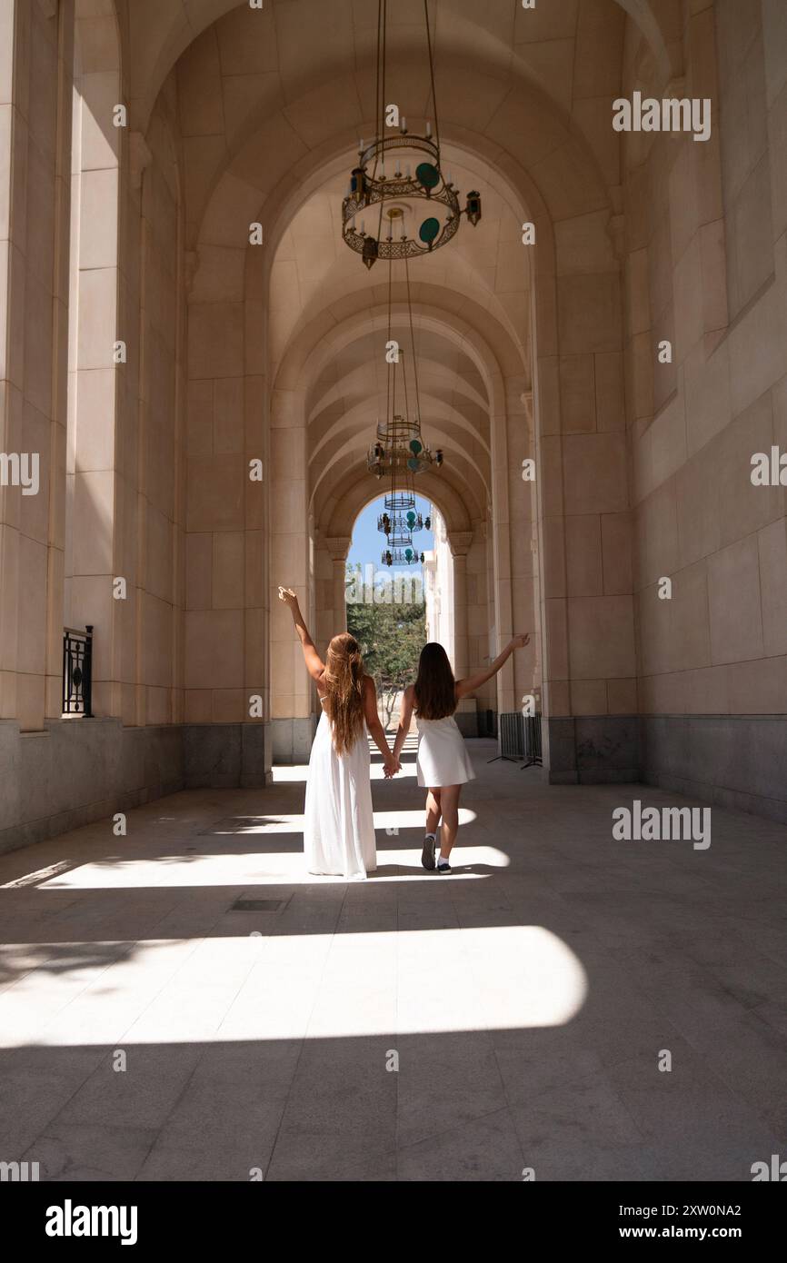 Women, Arches, Hallway - Two women walk through a long hallway with ...