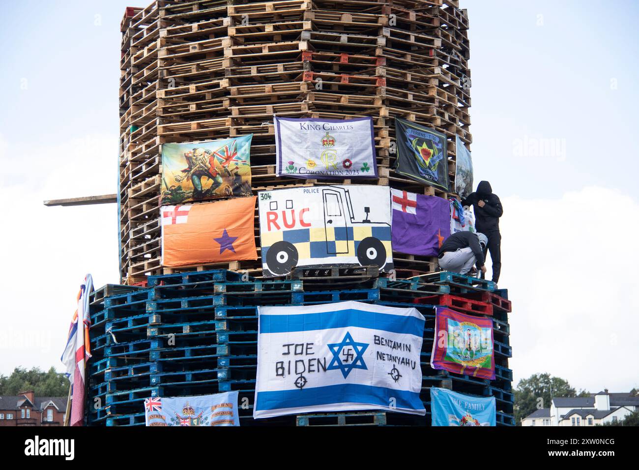 Nationalist youths building the controversial Bonfire in Derry's ...