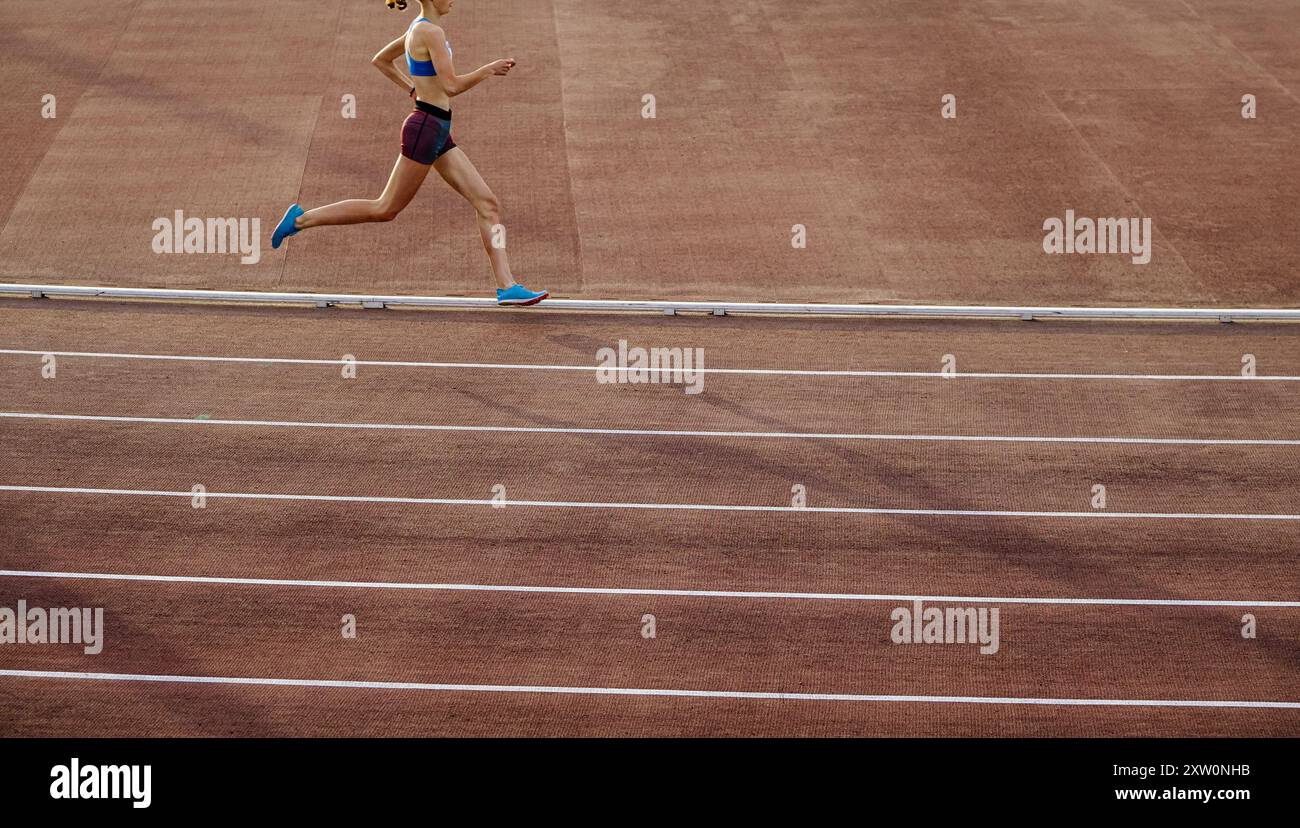 woman athlete running middle distance race in stadium Stock Photo - Alamy