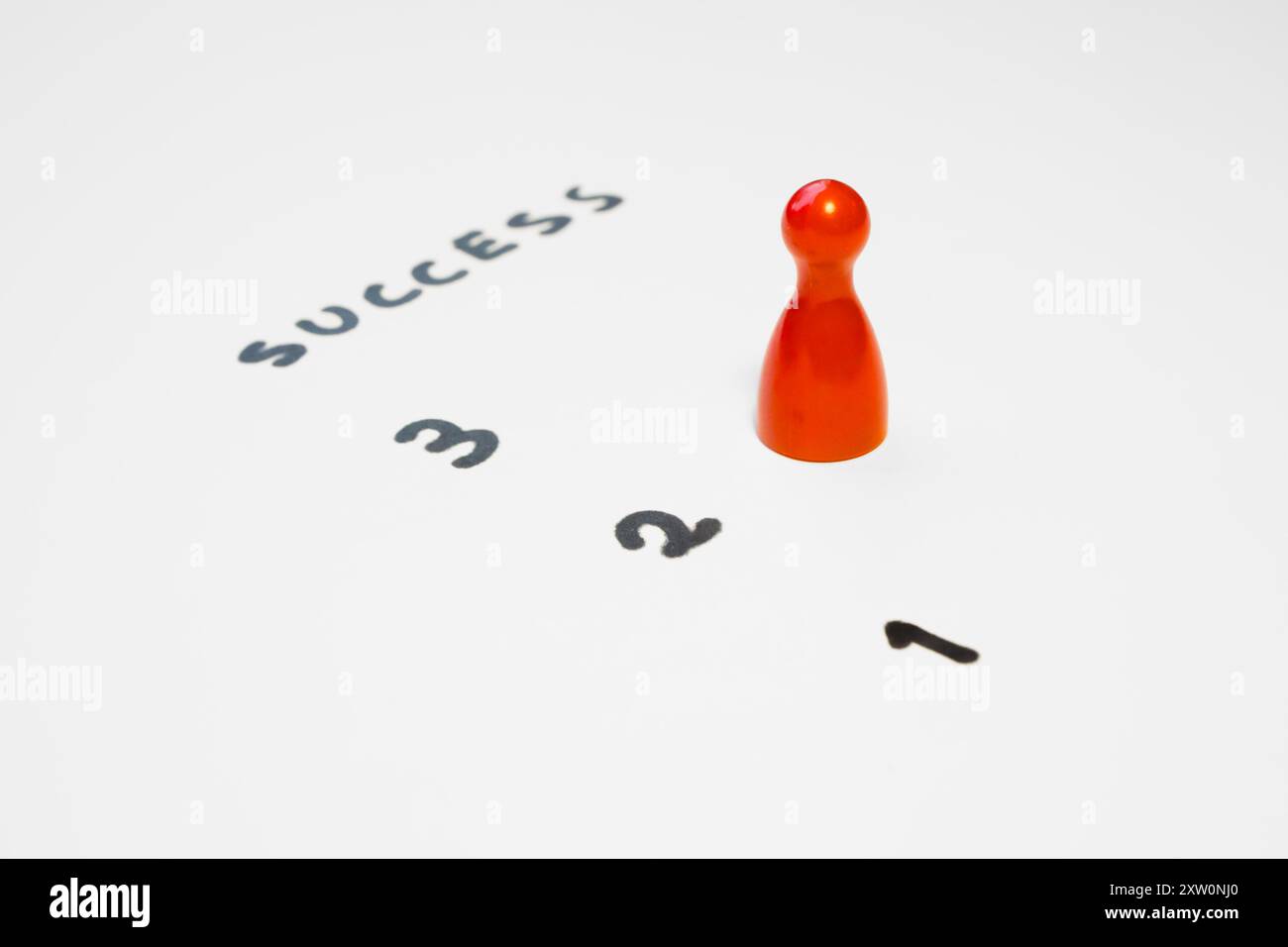 Steps to success with red game piece Stock Photo - Alamy