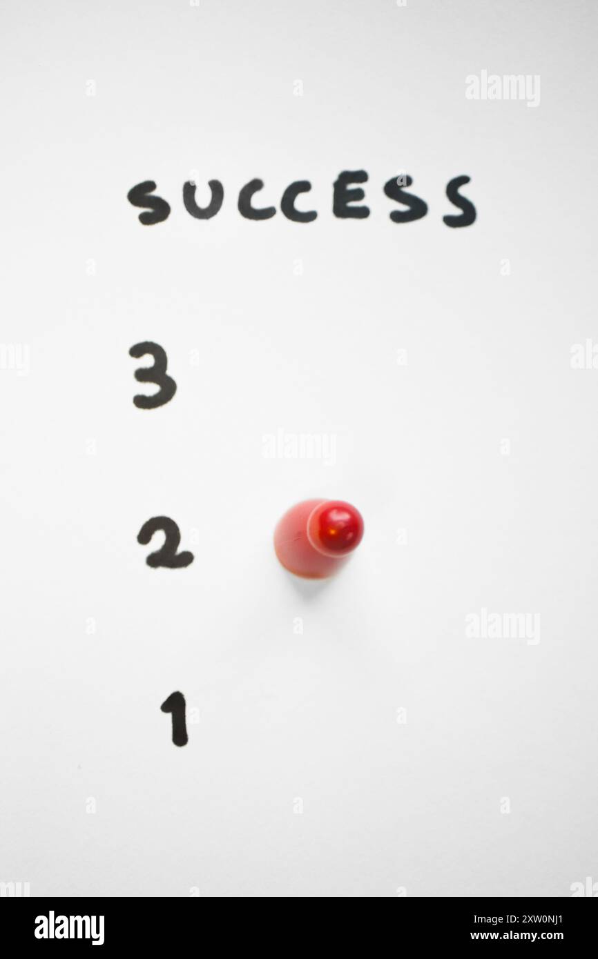 Steps to success with red game piece Stock Photo - Alamy