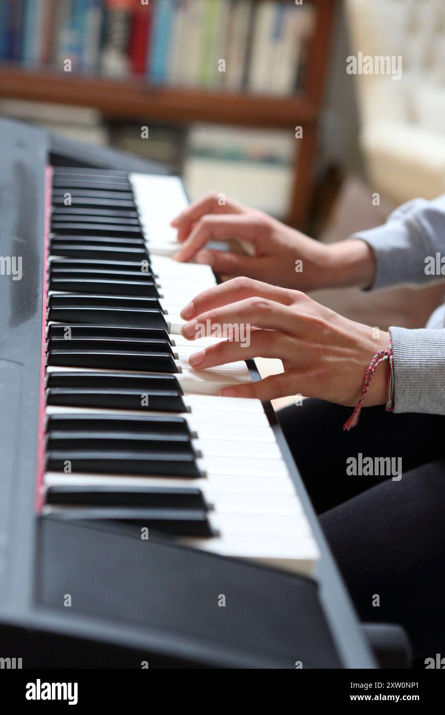 Girls hands playing keyboard - music keys Stock Photo - Alamy