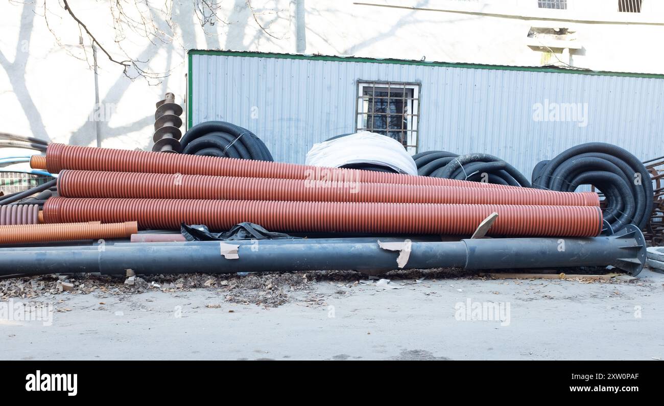 Construction Materials with Stacked Pipes Outdoors Stock Photo - Alamy