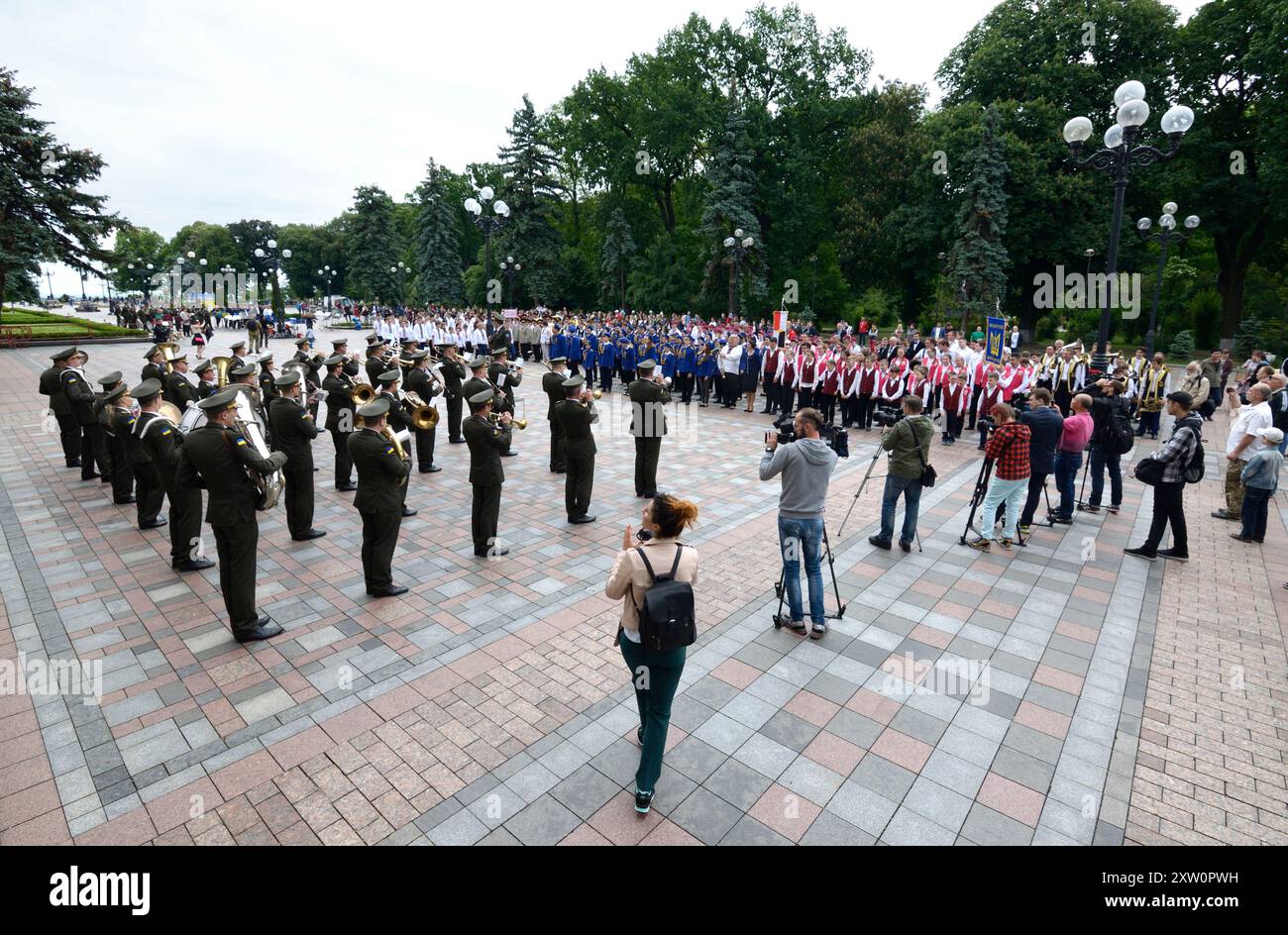 Military brass orchestra playing music on a square, crowd of people ...