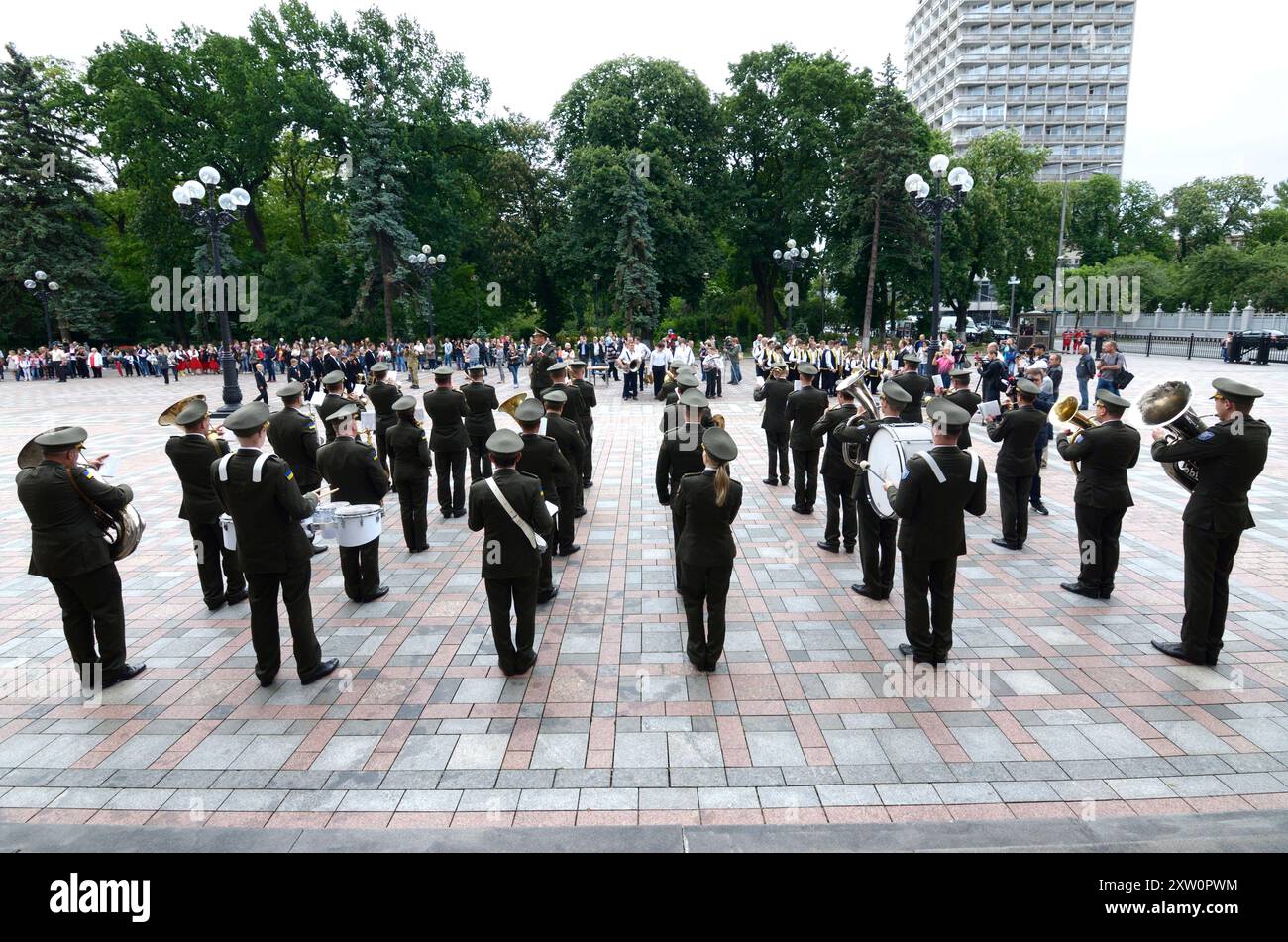 Military brass orchestra playing music on a square, crowd of people ...