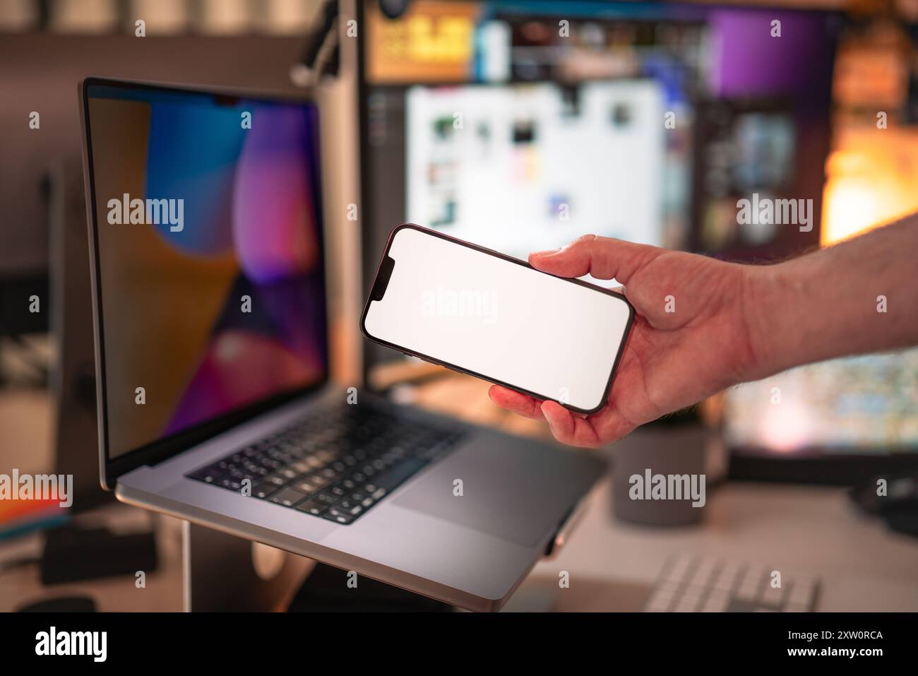 Smartphone blank screen mockup. Office interior. Laptop with external ...