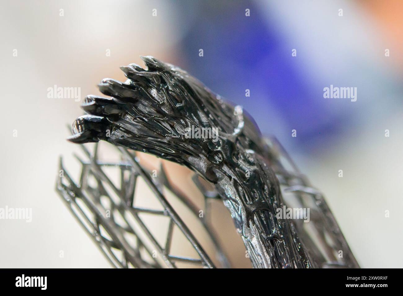 Model of leg printed on a 3D printer from black rubber, close-up. Part of an object created on a ...
