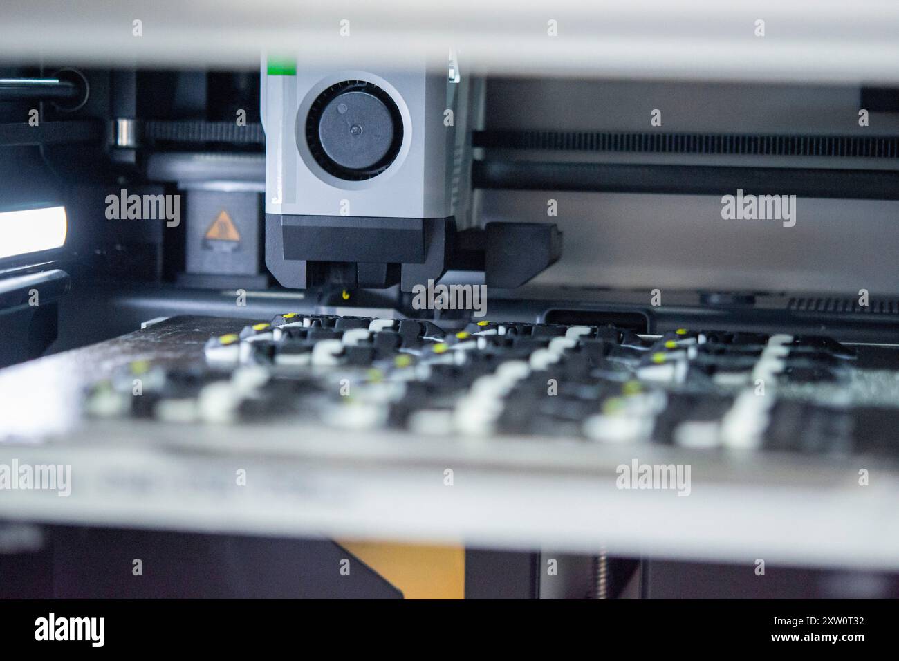 3D printer close up. A working 3D printer in process of printing object ...