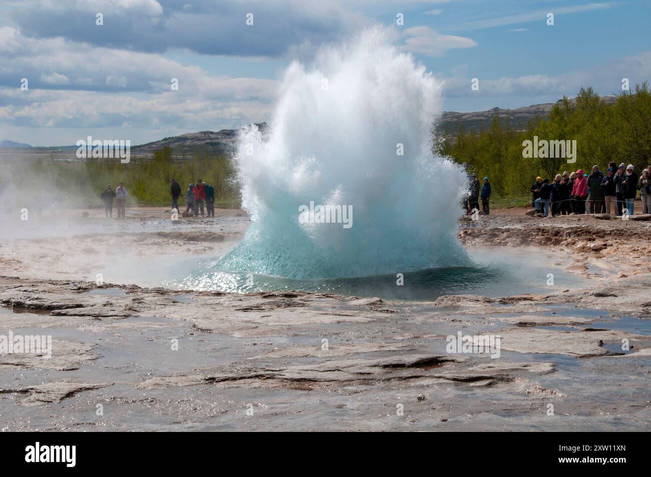 Geysir Iceland, people watching strokkur geyser erupting shooting ...