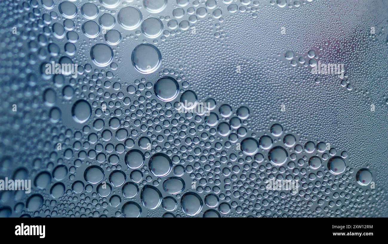 Many silver bubbles in water close up on a blue background. Background ...