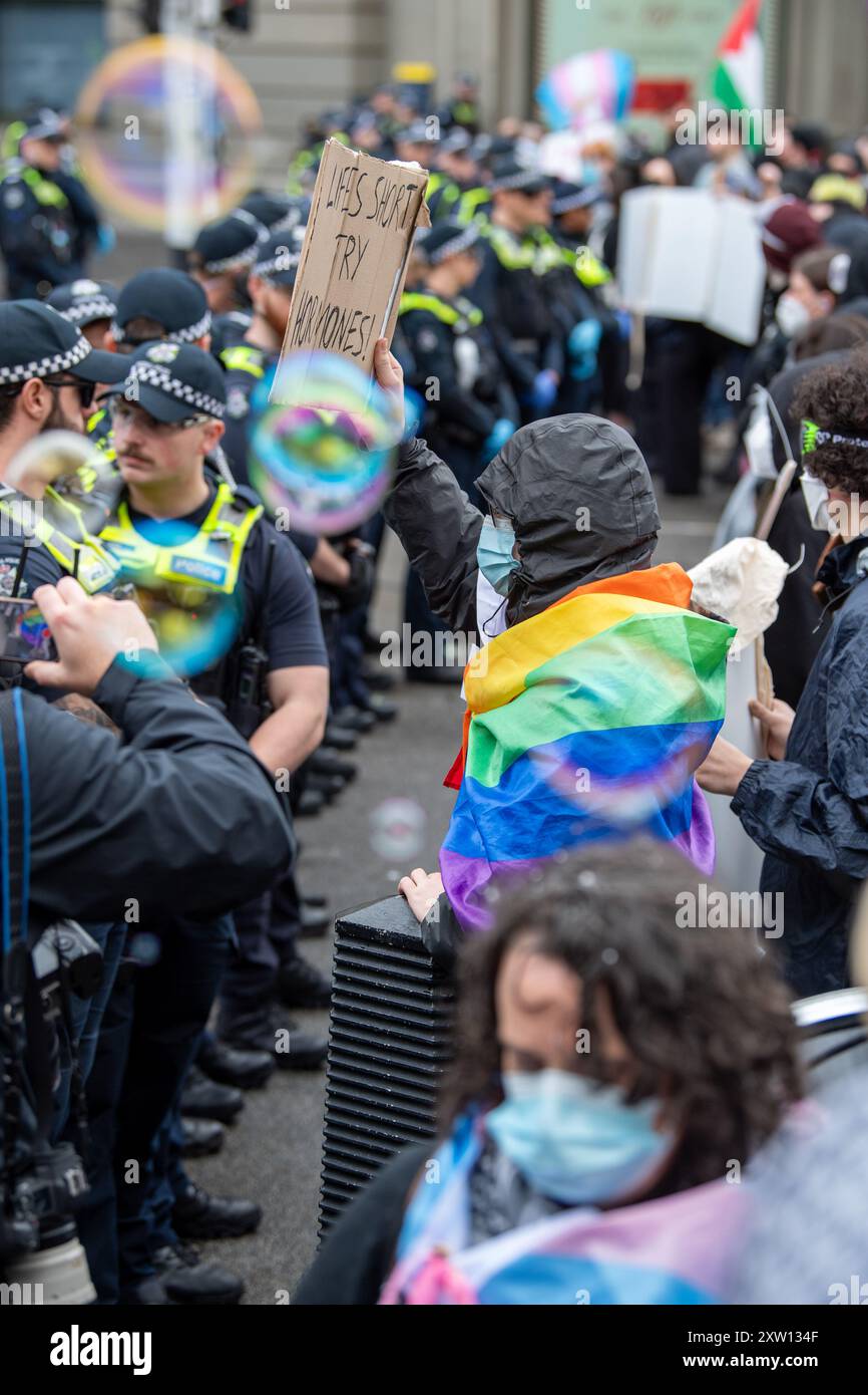 Melbourne, Australia. 17th Aug, 2024. Pro-trans protesters hold up ...