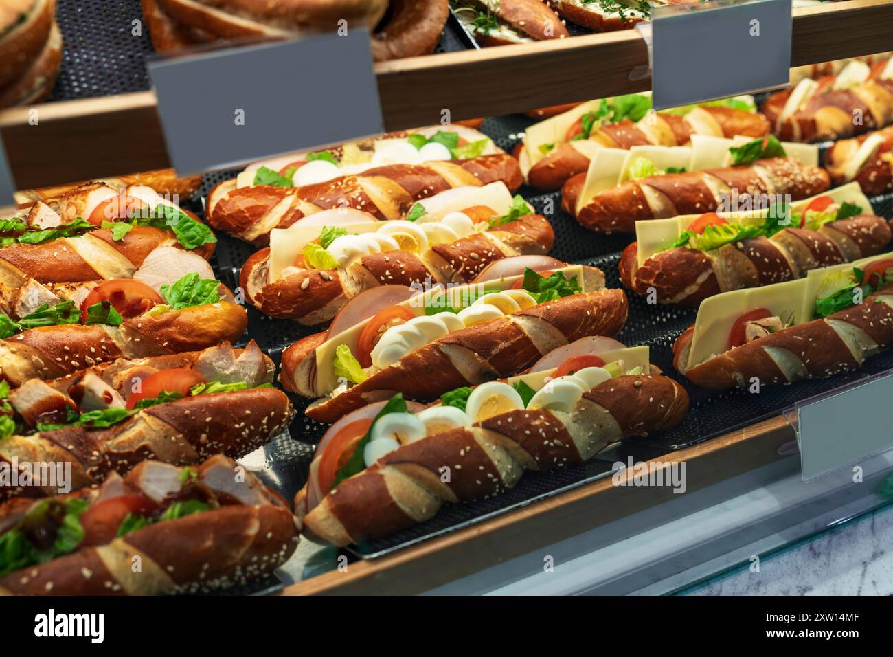 meat sandwiches and vegan sandwiches on display at a coffee shop ...