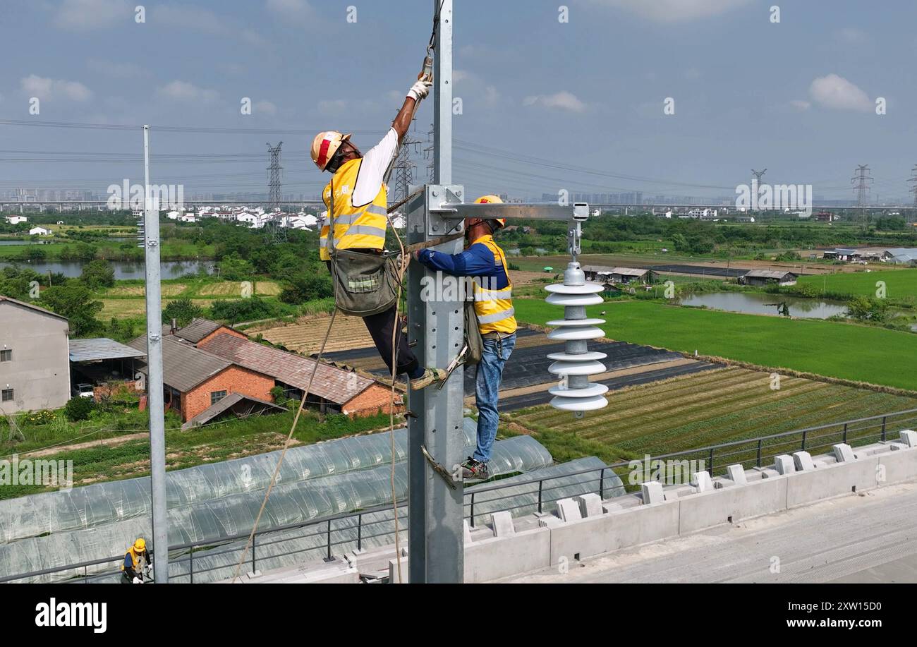 NANCHANG, CHINA - AUGUST 16, 2024 - Construction workers install ...