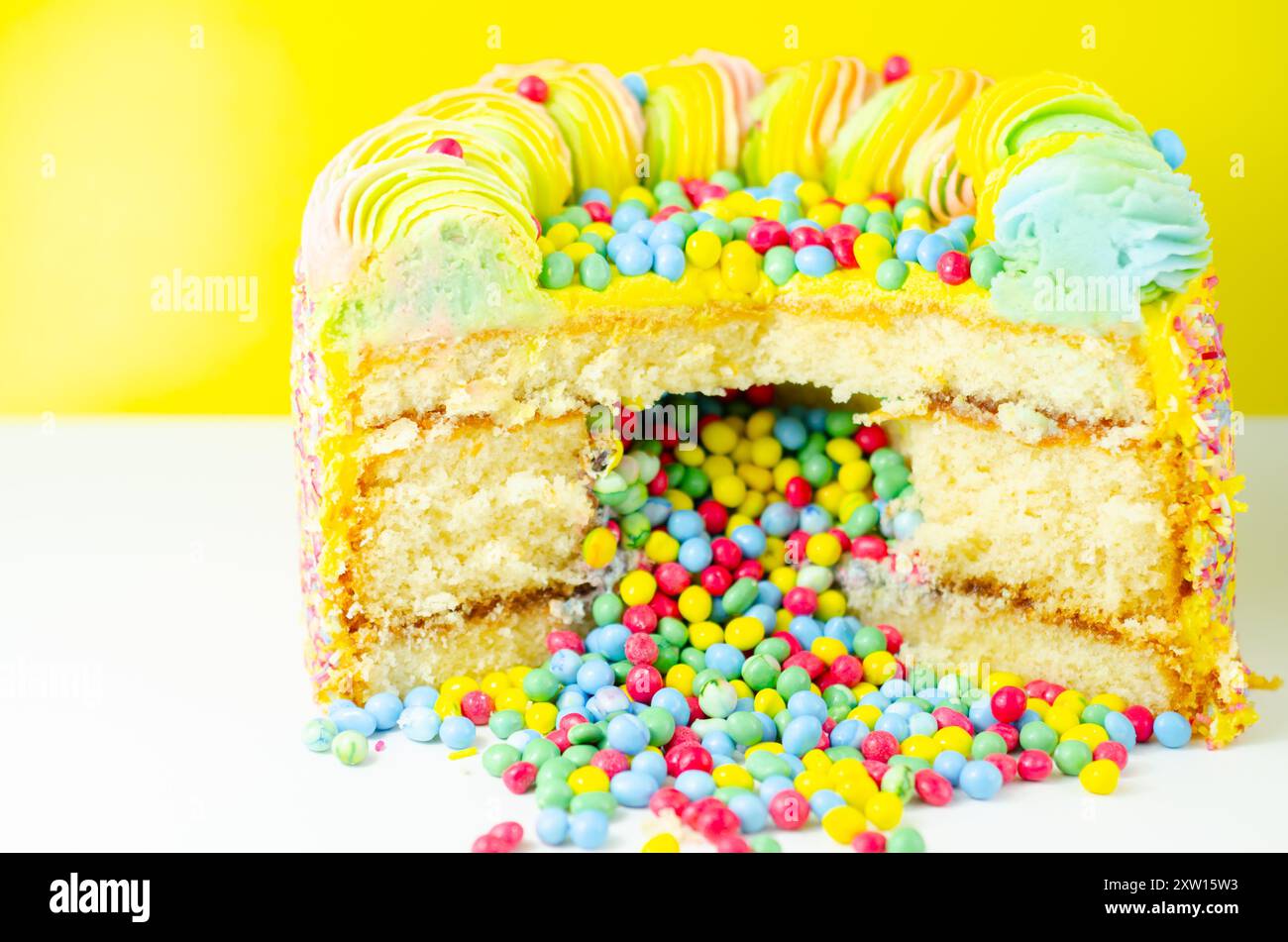 A cake with colorful sprinkles and a hole in the middle. The cake is ...