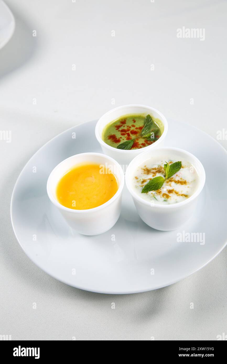 Different tasty sauces in bowls on white table, flat lay. Restaurant ...
