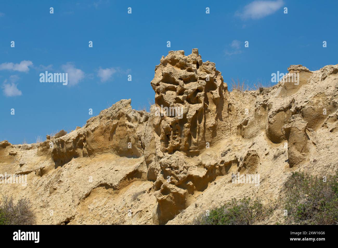 Rock formation resembling a face is emerging from a cliff on a sunny ...