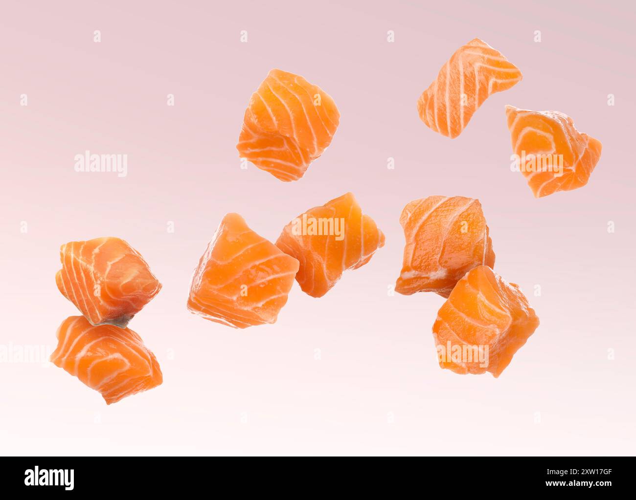 Fresh raw salmon pieces in air on pink gradient background Stock Photo ...