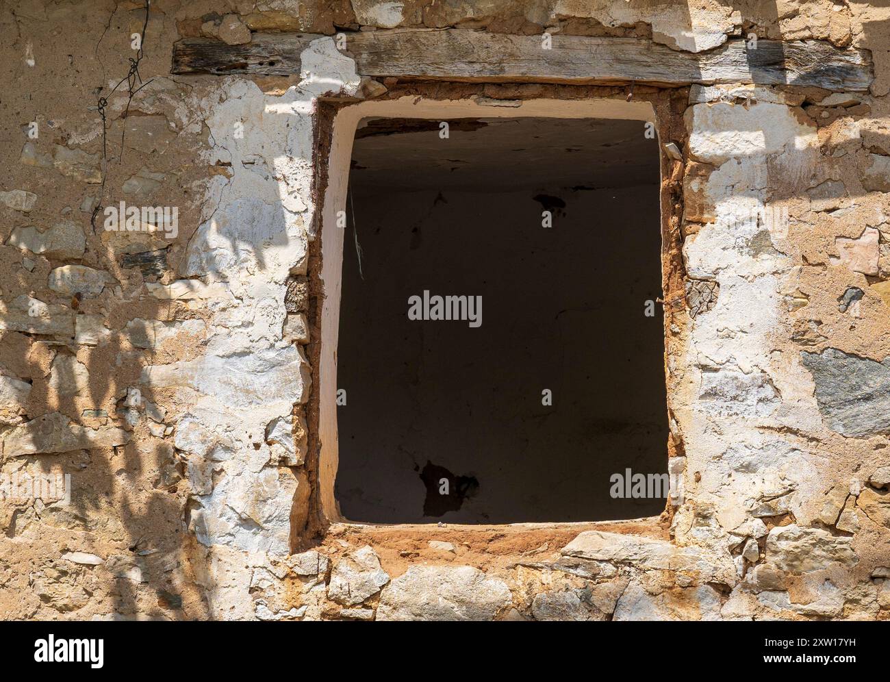 Empty Window Frame in an Abandoned Old House. Shadows of tree branches ...