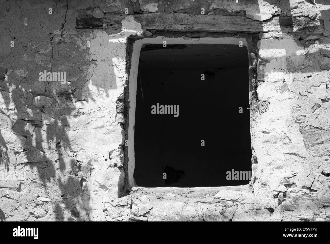 Empty Window Frame in an Abandoned Old House. Shadows of tree branches ...